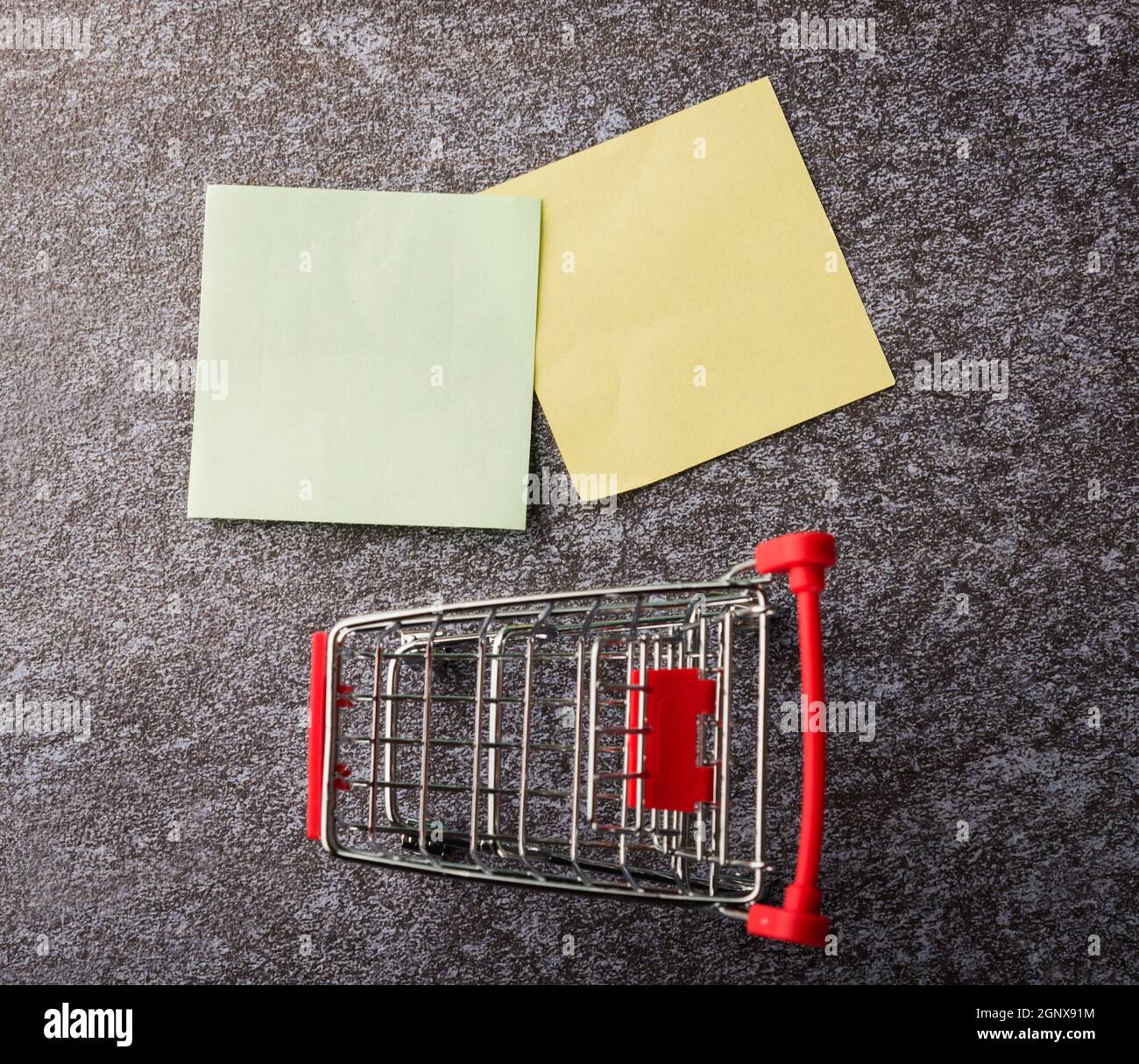 Above blank paper stick note list yellow and green with the shopping ...