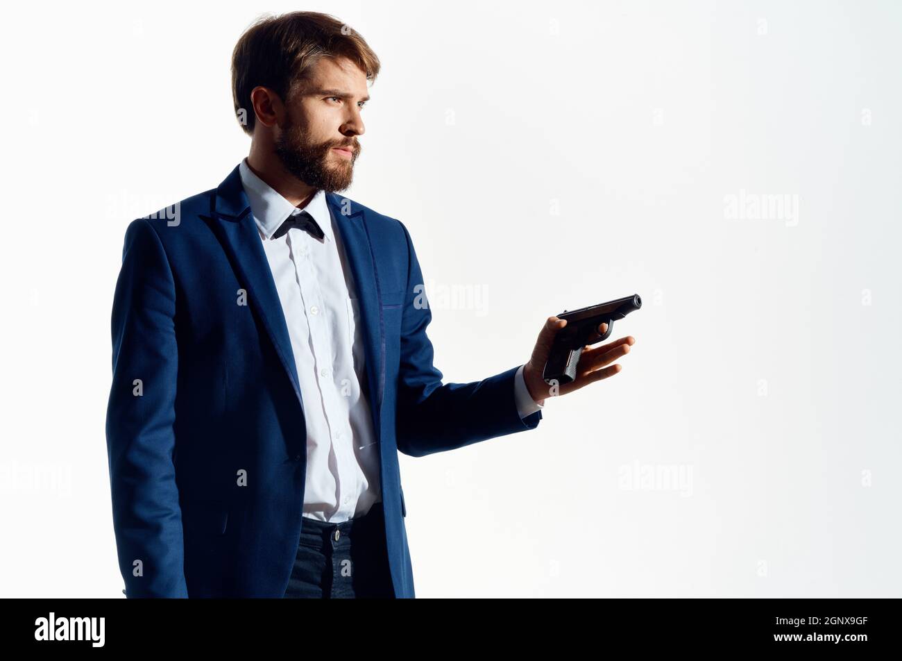 Man Secret agent with a gun in the hands of a crime isolated background ...