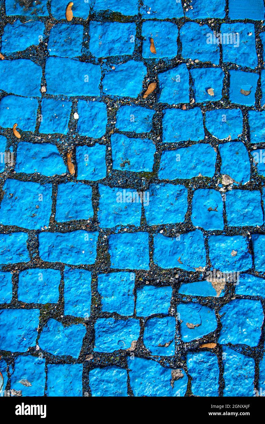 blue painted cobblestones, parking for handicapped Stock Photo - Alamy