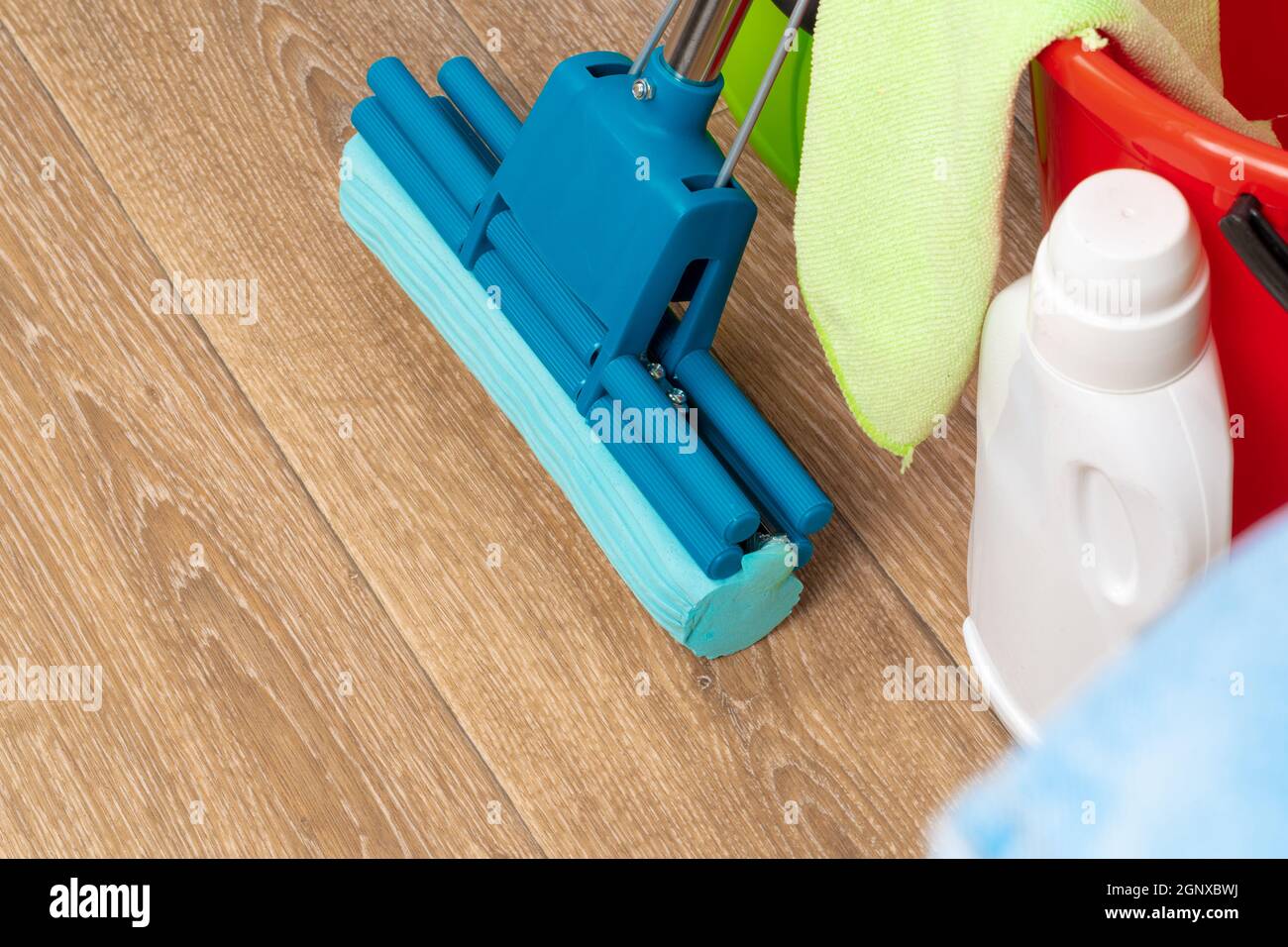 Cleaning tools for house cleaning on wooden floor Stock Photo - Alamy