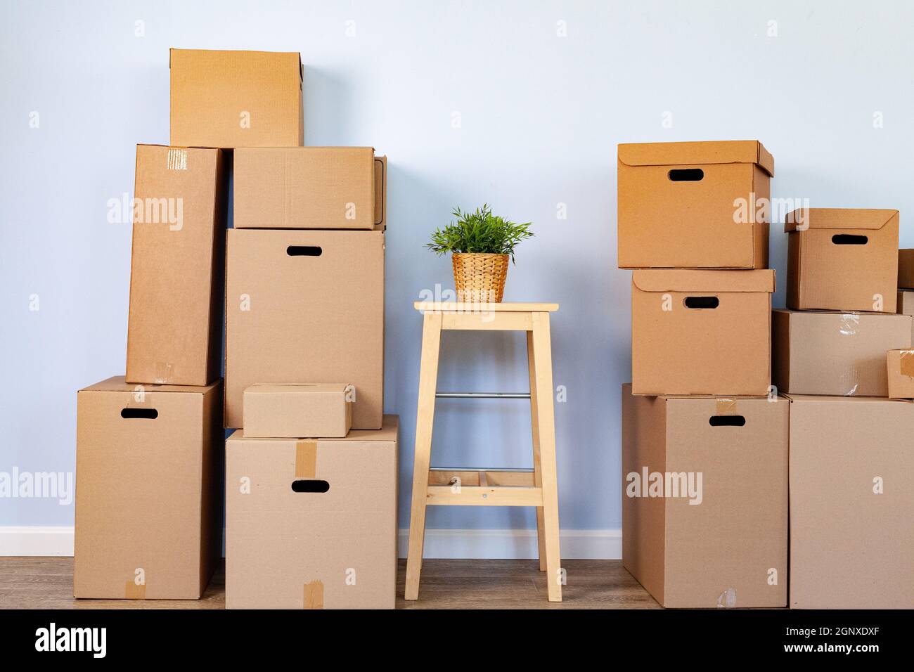 Moving boxes with packed stuff and chair for moving Stock Photo - Alamy