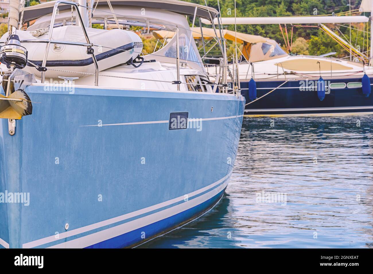 Blue and white motor yacht berth in marina, side view Stock Photo - Alamy