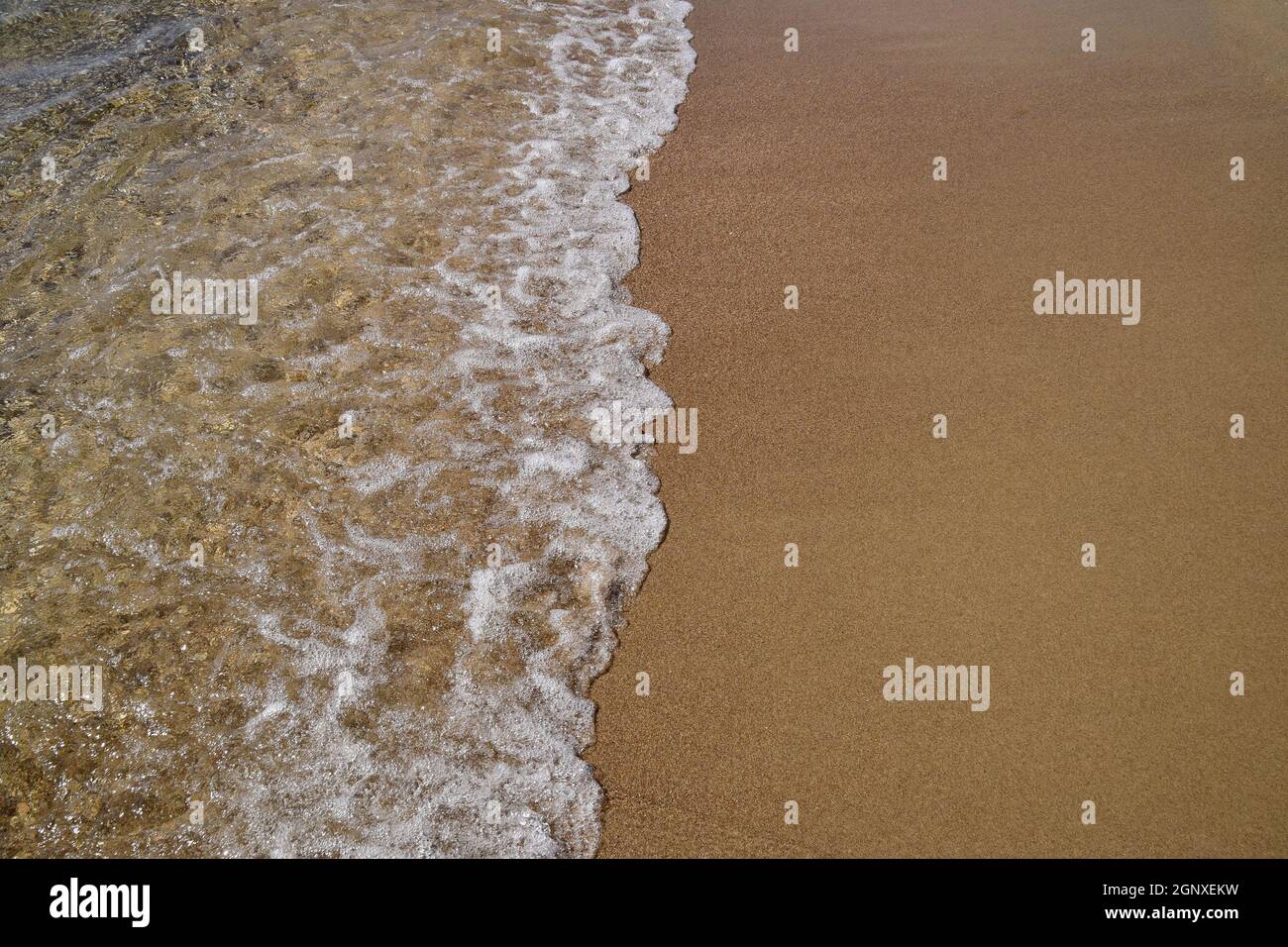 Waves lapping on the sandy shore. Sea beach Stock Photo - Alamy