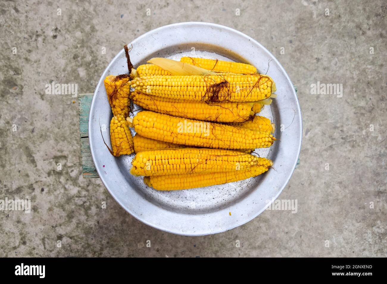 Boiled corn on an aluminum tray. Yellow boiled young corn, useful and ...