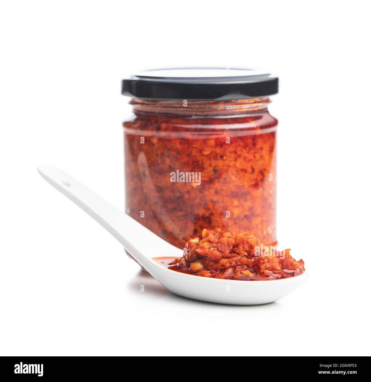 Red hot chili paste in ceramic spoon isolated on white background Stock ...
