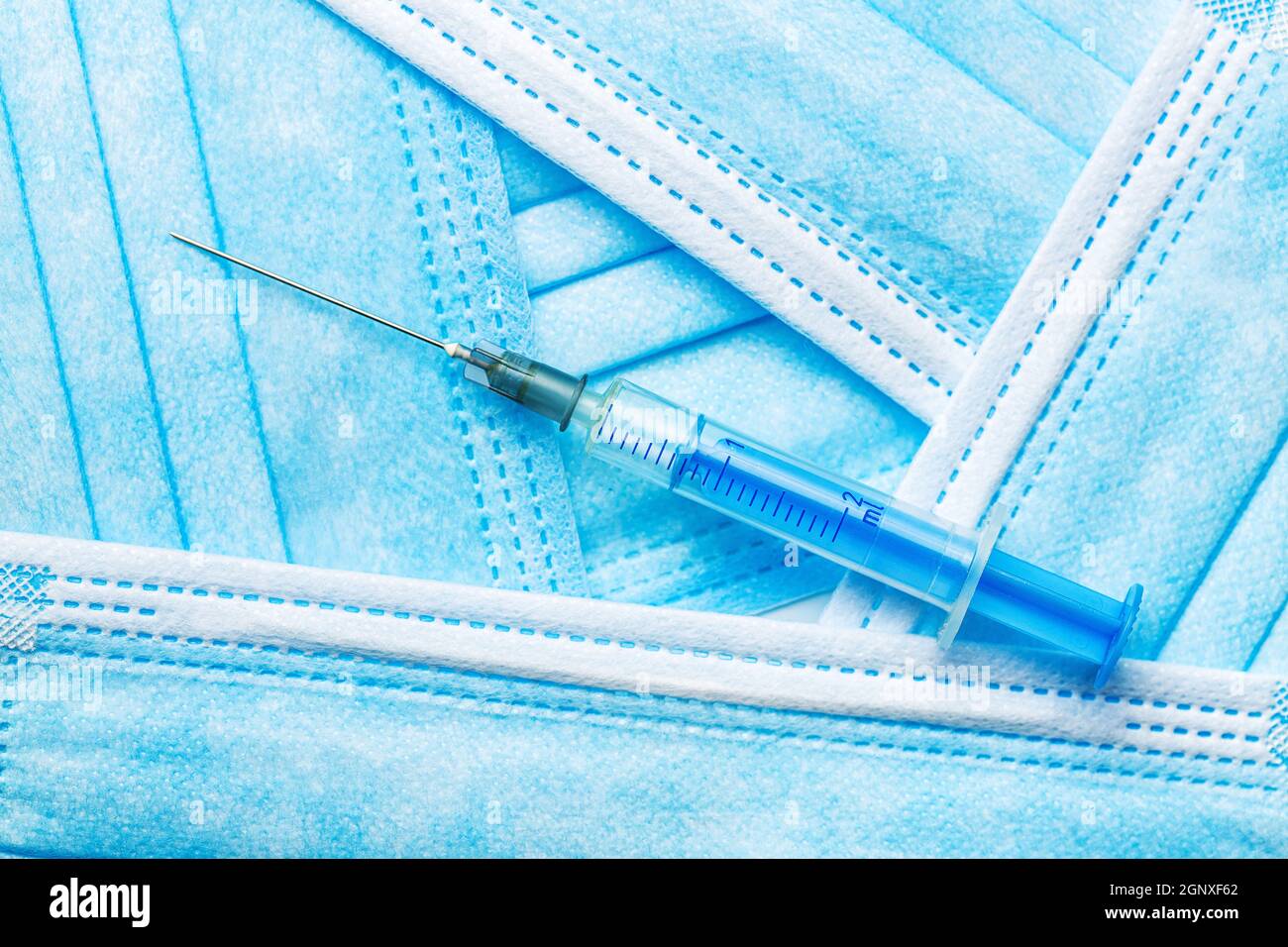 Injection syringe and protection face masks. Covid-19 coronavirus ...