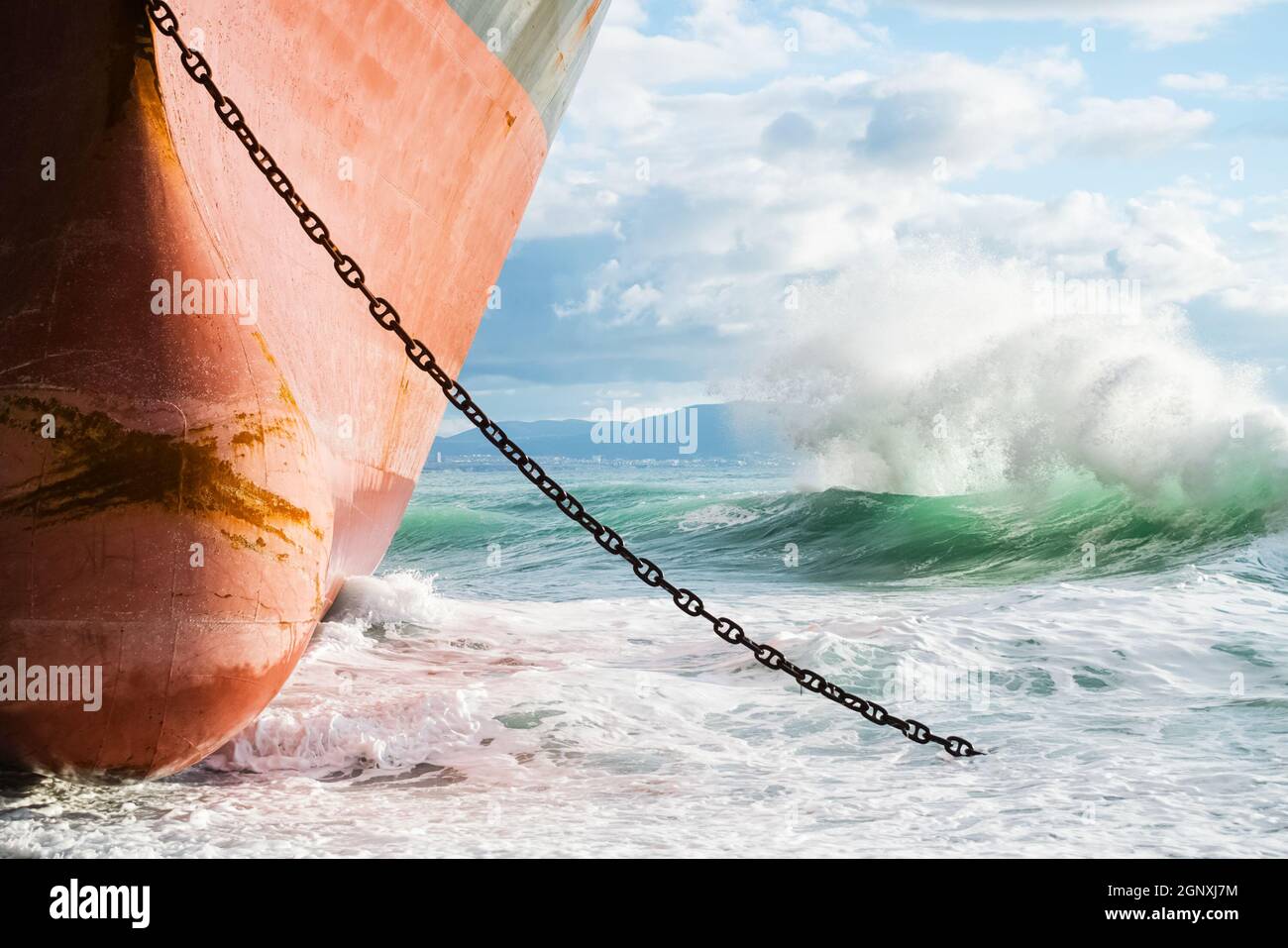 A stranded ship on the shore. Waves are hitting the ship side by side ...