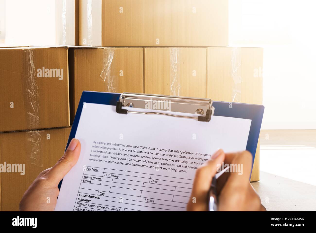 African Courier Delivery Woman Writing In Clipboard Stock Photo - Alamy