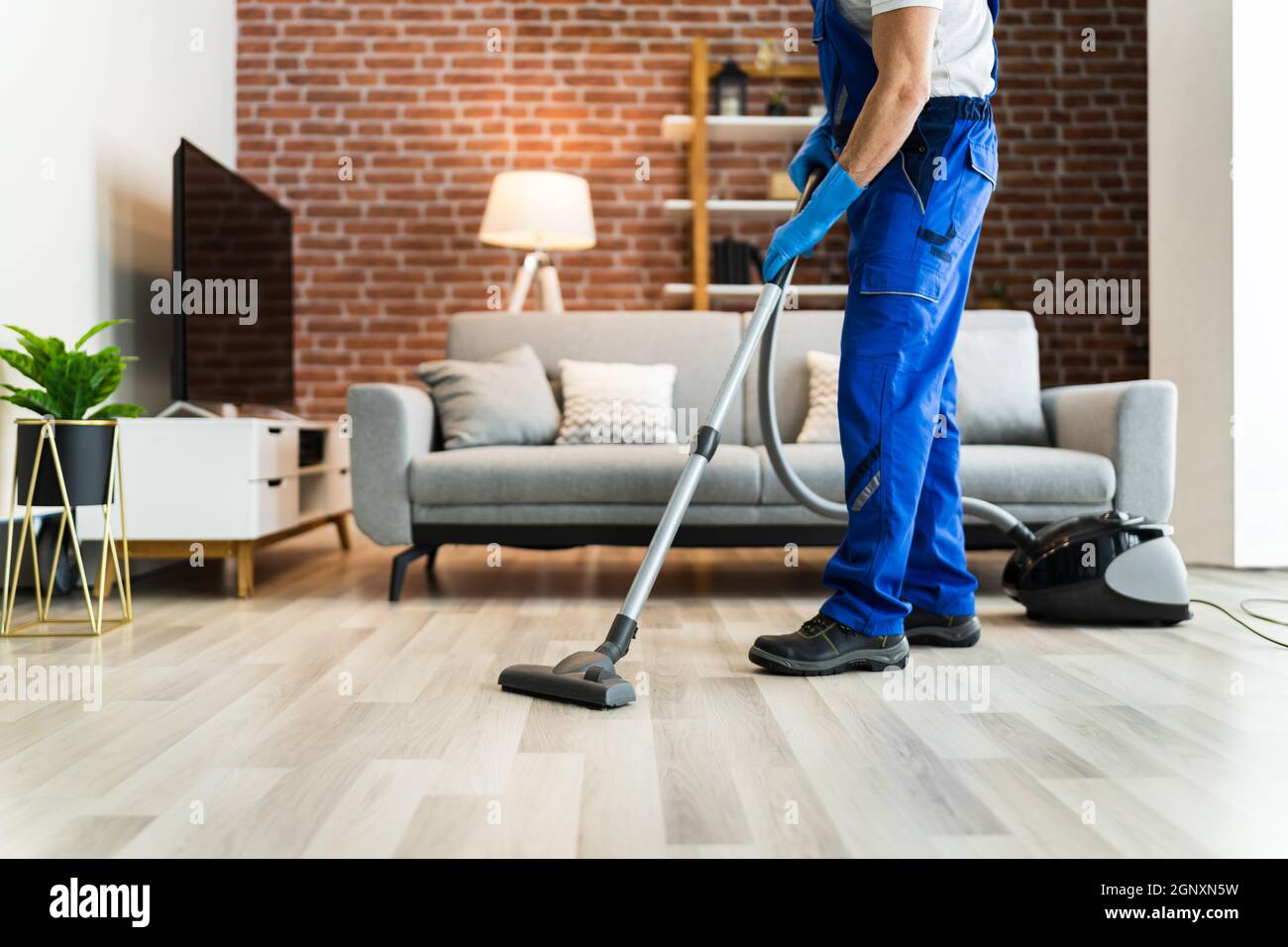 Worker vacuuming floor in hi-res stock photography and images - Alamy