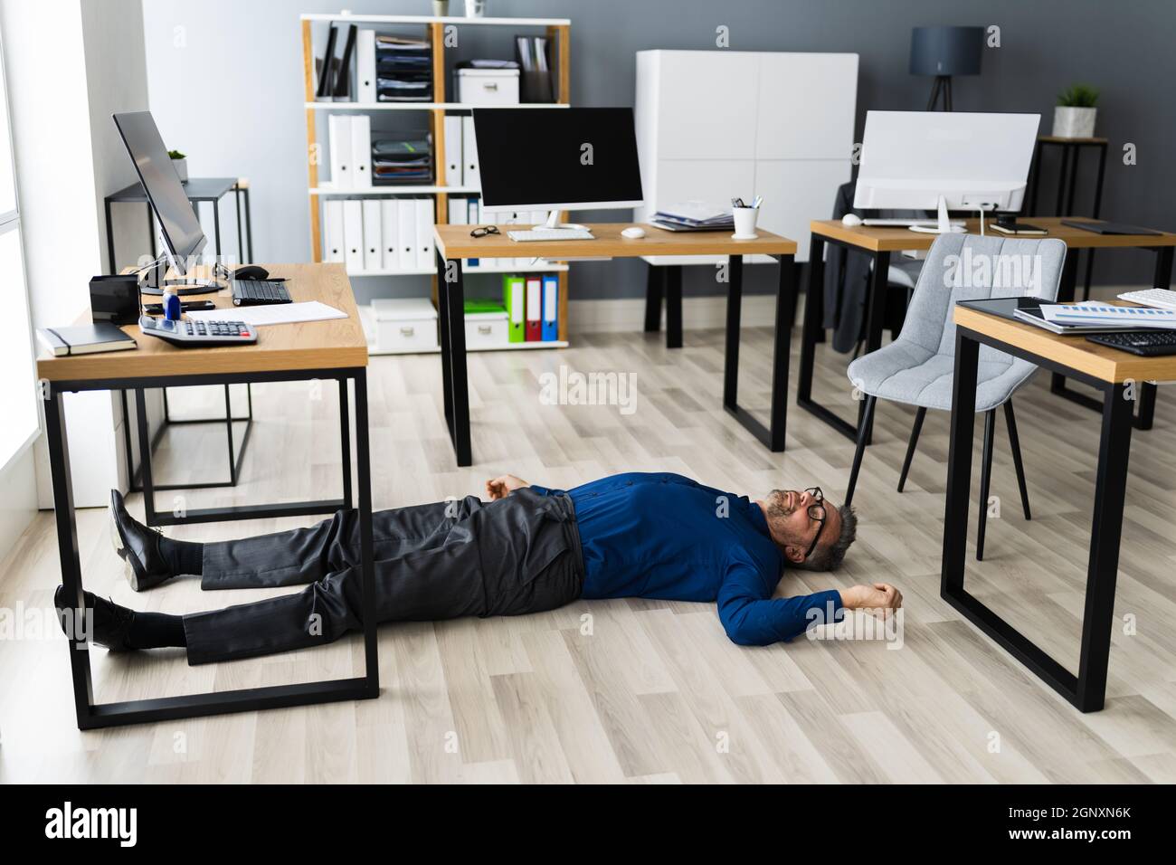 Office Slip And Fall Accident. Fainted Man At Workplace Stock Photo - Alamy