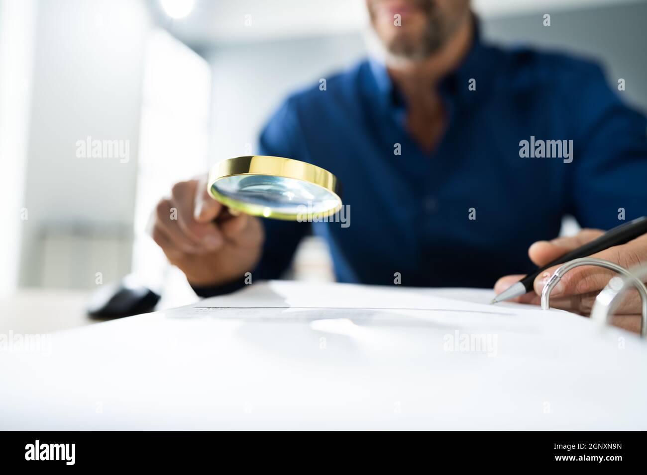 Fraud Detective Using Magnifying Glass Or Loupe Stock Photo - Alamy