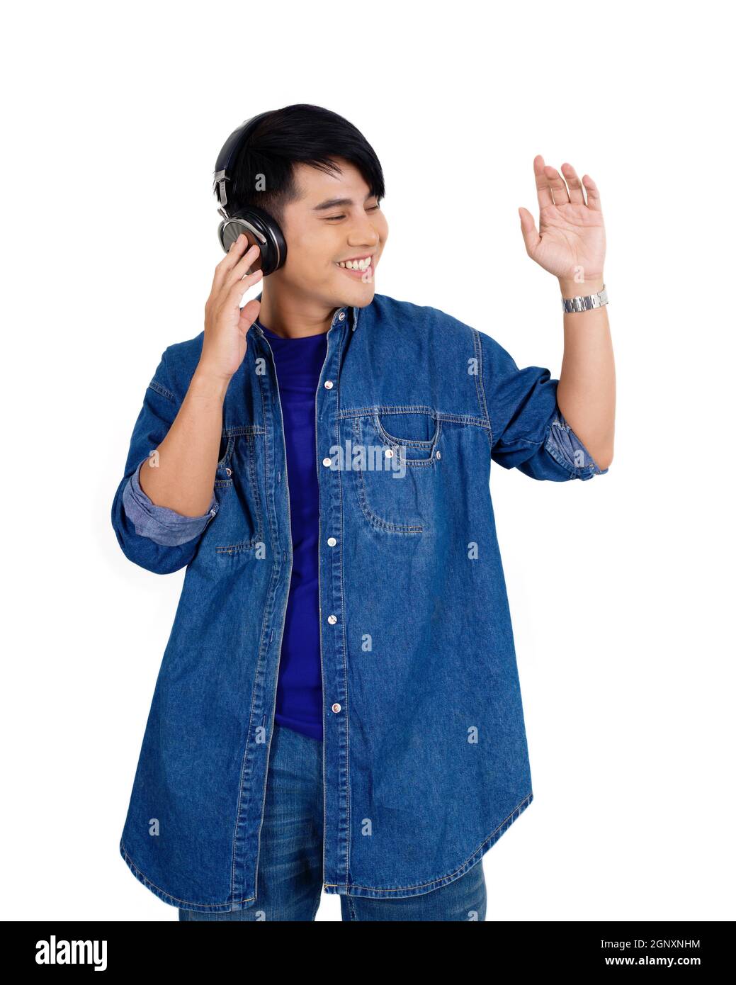 Young asian man dance, swaying, and lifting his arms rhythmically while ...