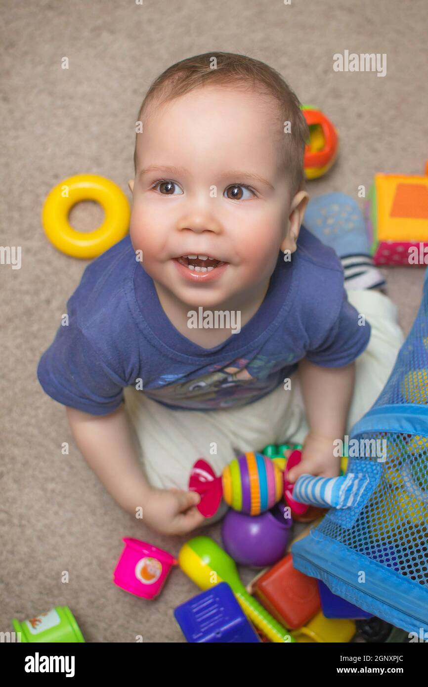 curious child studying toys at home Stock Photo - Alamy