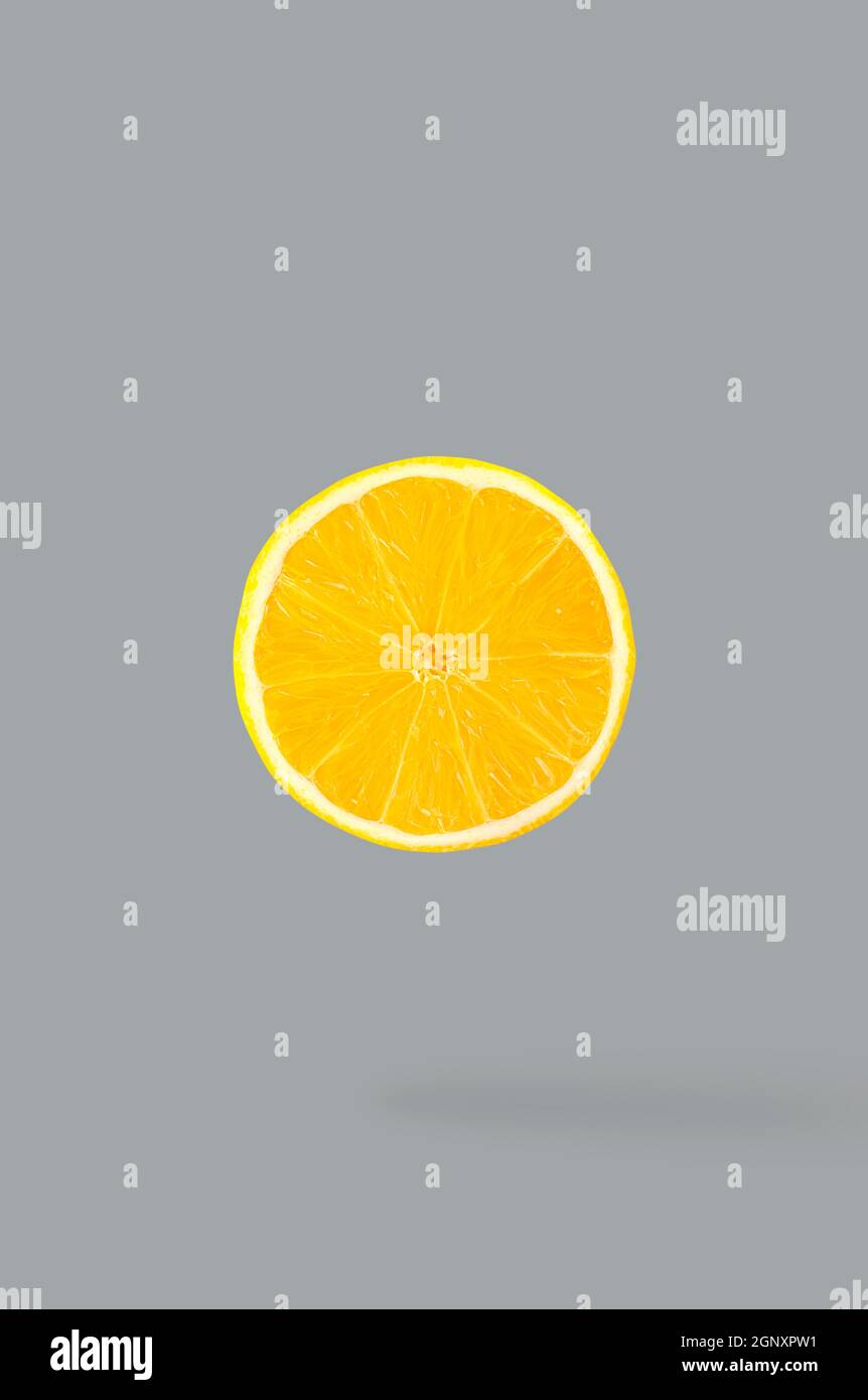Minimal fruit concept. One slice of lemon with shadow. Illuminating ...