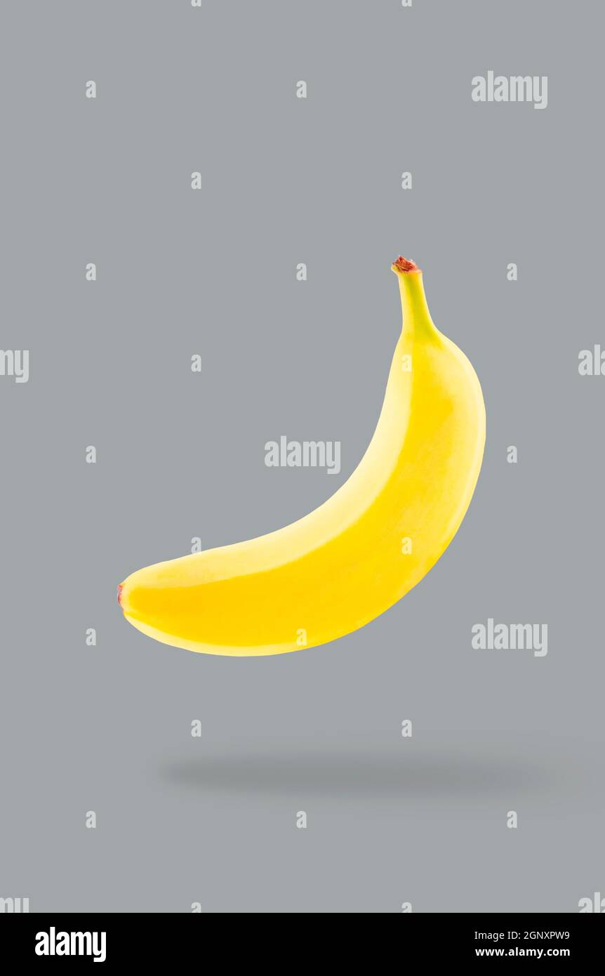 Minimal fruit concept. One whole banana with shadow. Illuminating ...