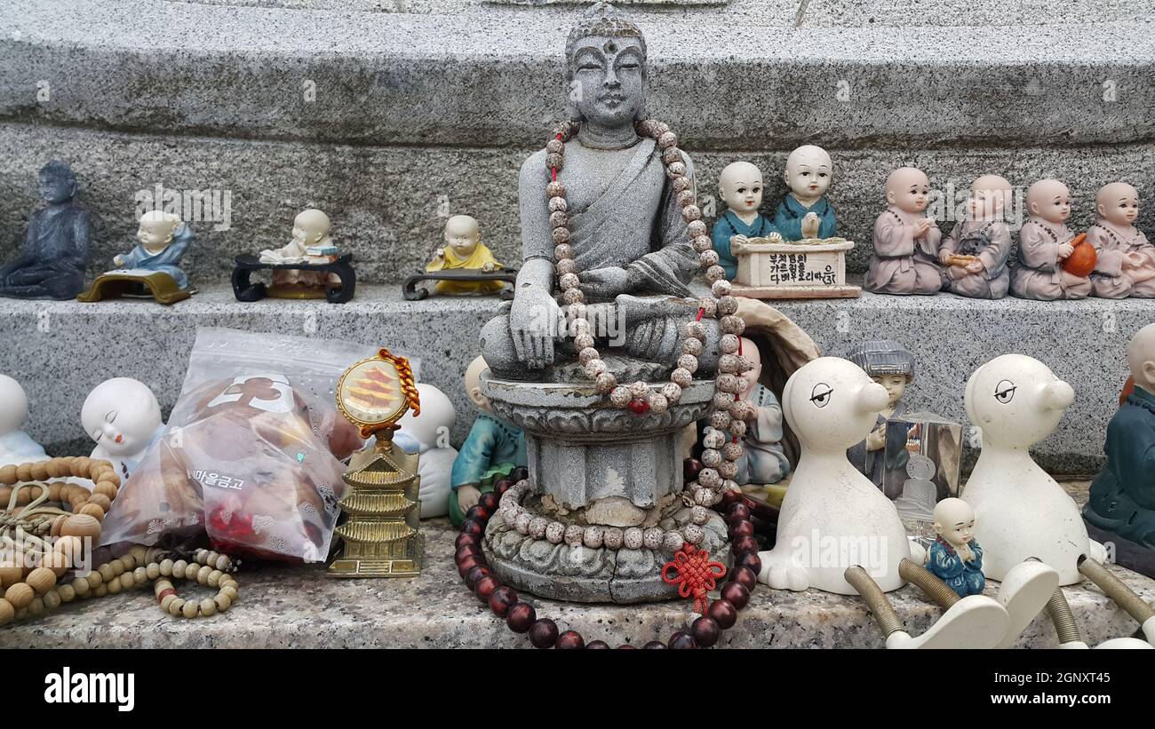 Closeup view of statues of religious monks. Buddha mini statue with ...