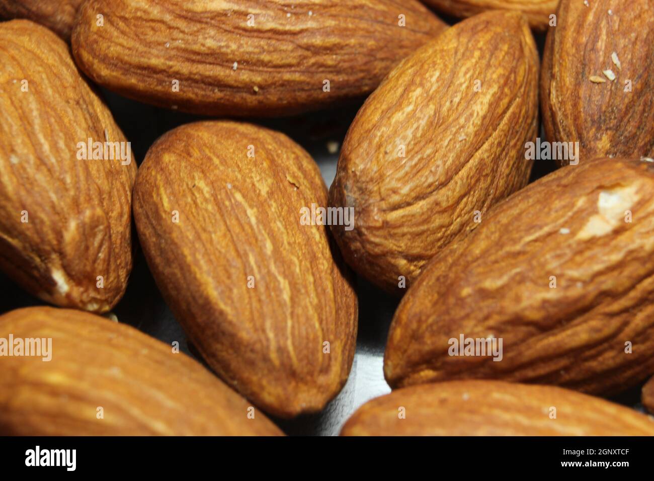 Fruit background of a pile of peeled almond nuts. Composition from ...