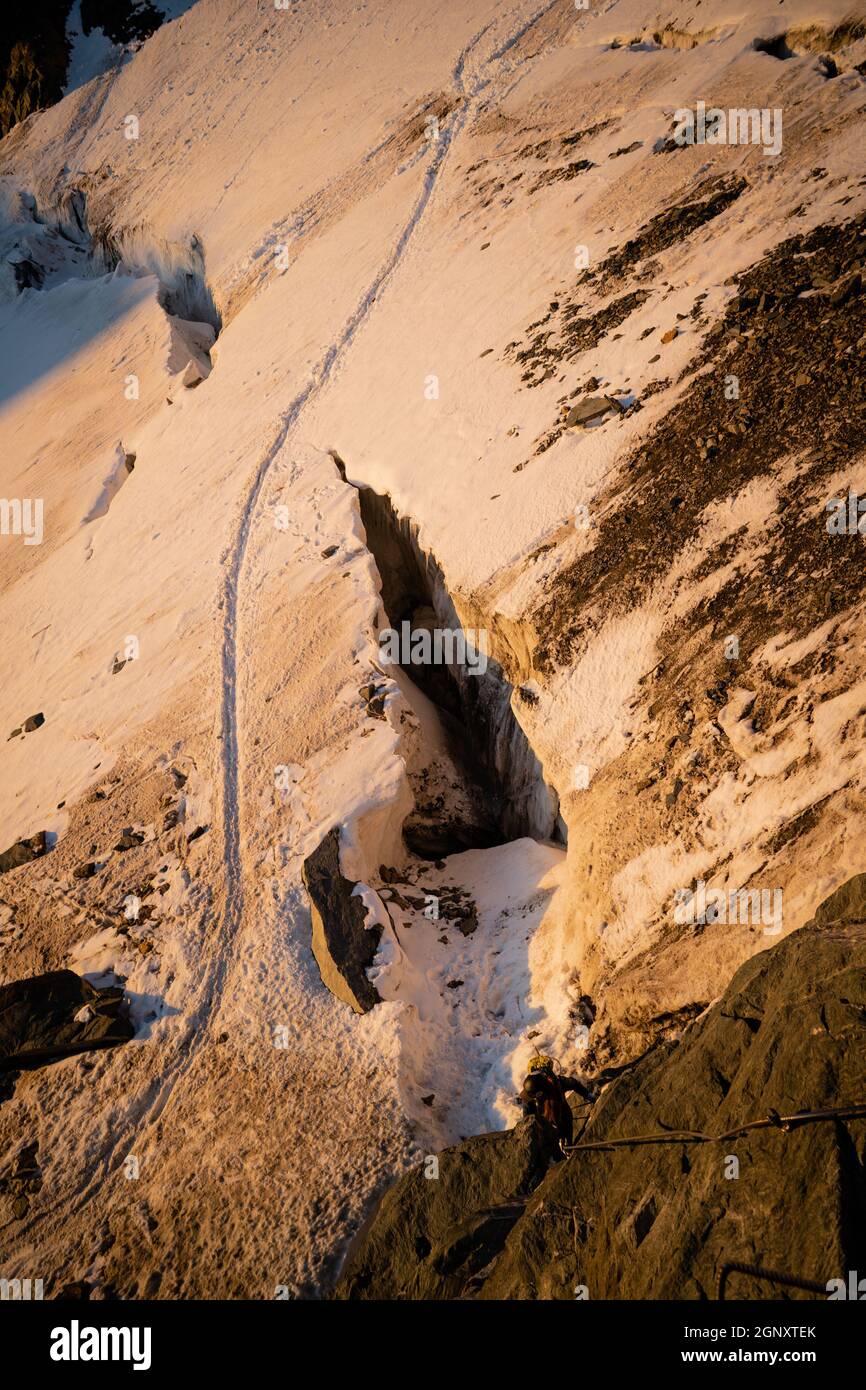 Giant crack in ice, destruction of a glacier in spring during sunset ...