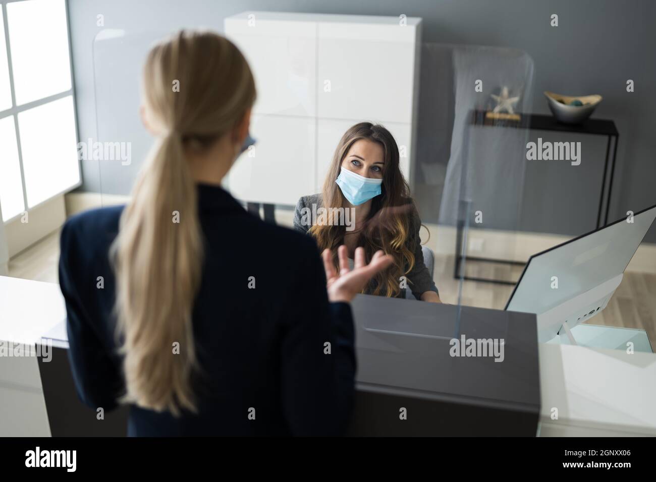 Client At Reception Desk Or Counter With Mask Stock Photo - Alamy