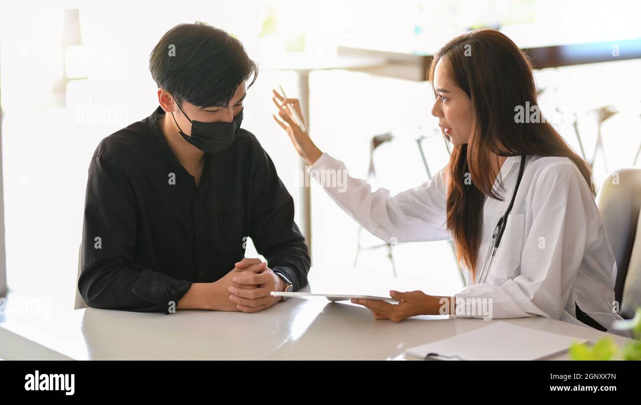 Female doctor comforts and supports male patient, expressing concern ...