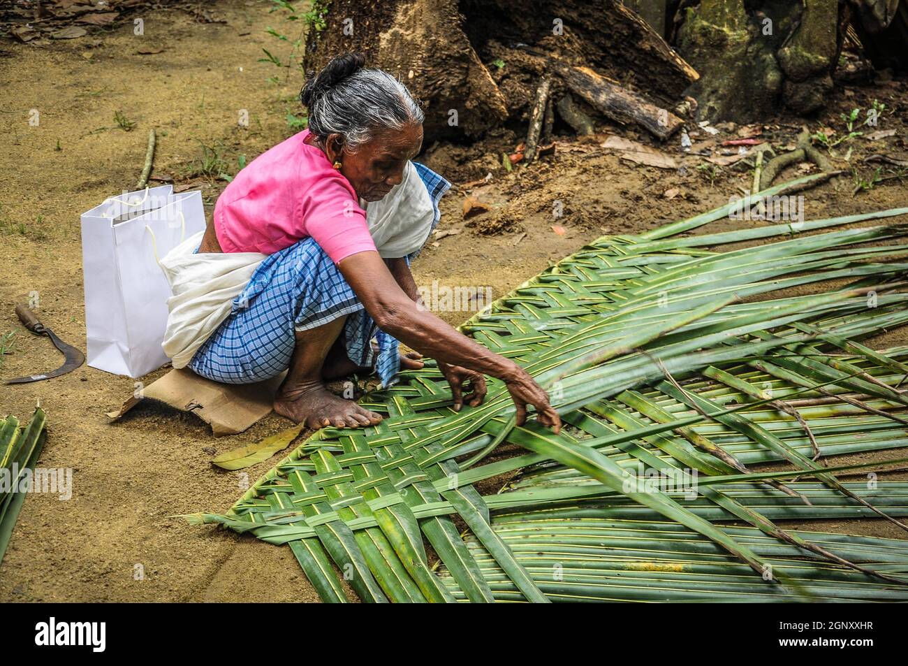A local woman works on weaving banana leaves Stock Photo - Alamy