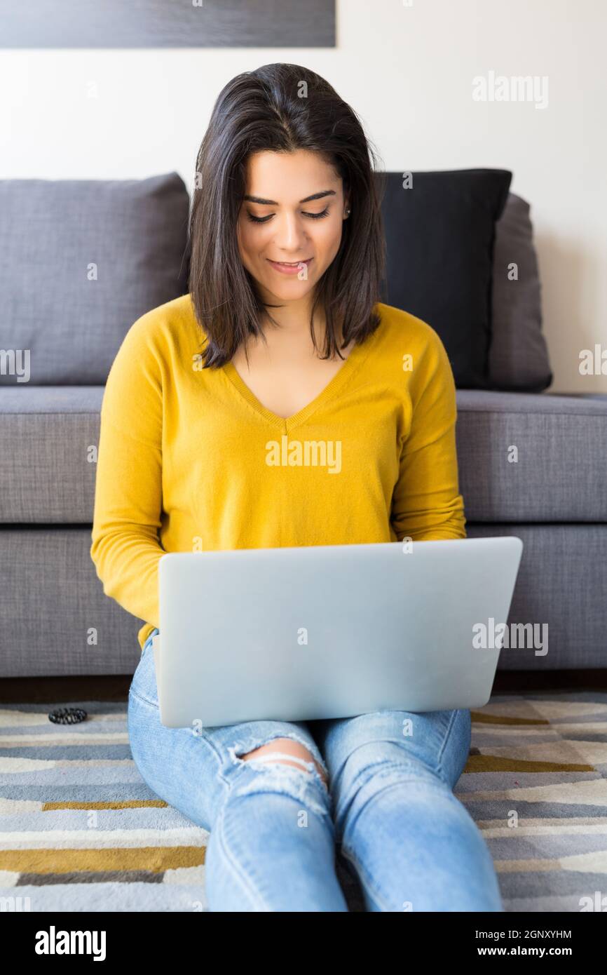 Beautiful woman relaxing with a computer Stock Photo - Alamy