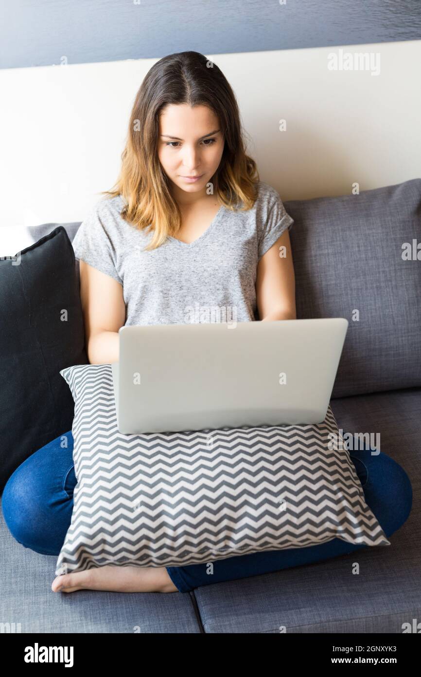 Beautiful woman relaxing with a computer Stock Photo - Alamy