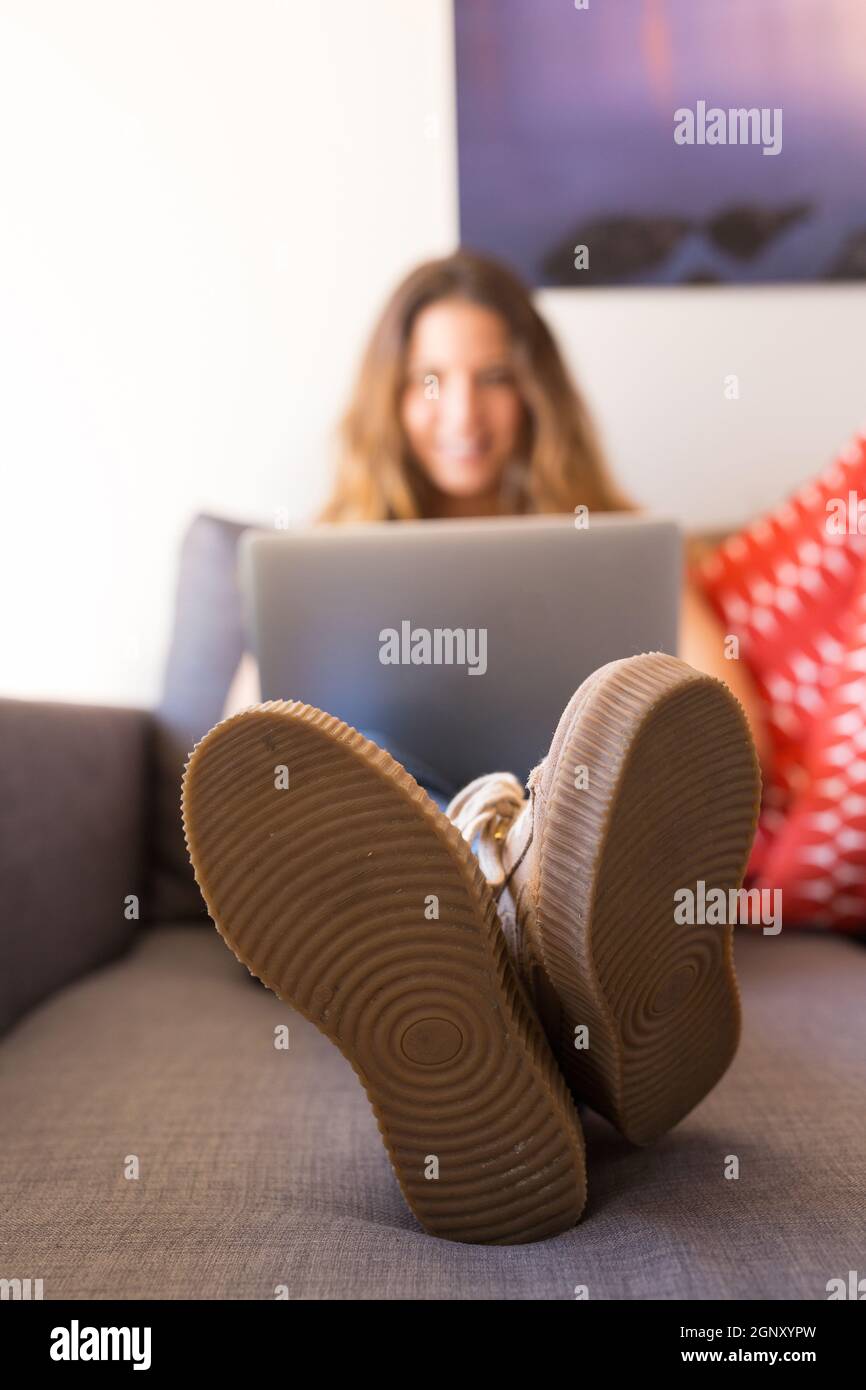 Beautiful woman relaxing with a computer Stock Photo - Alamy