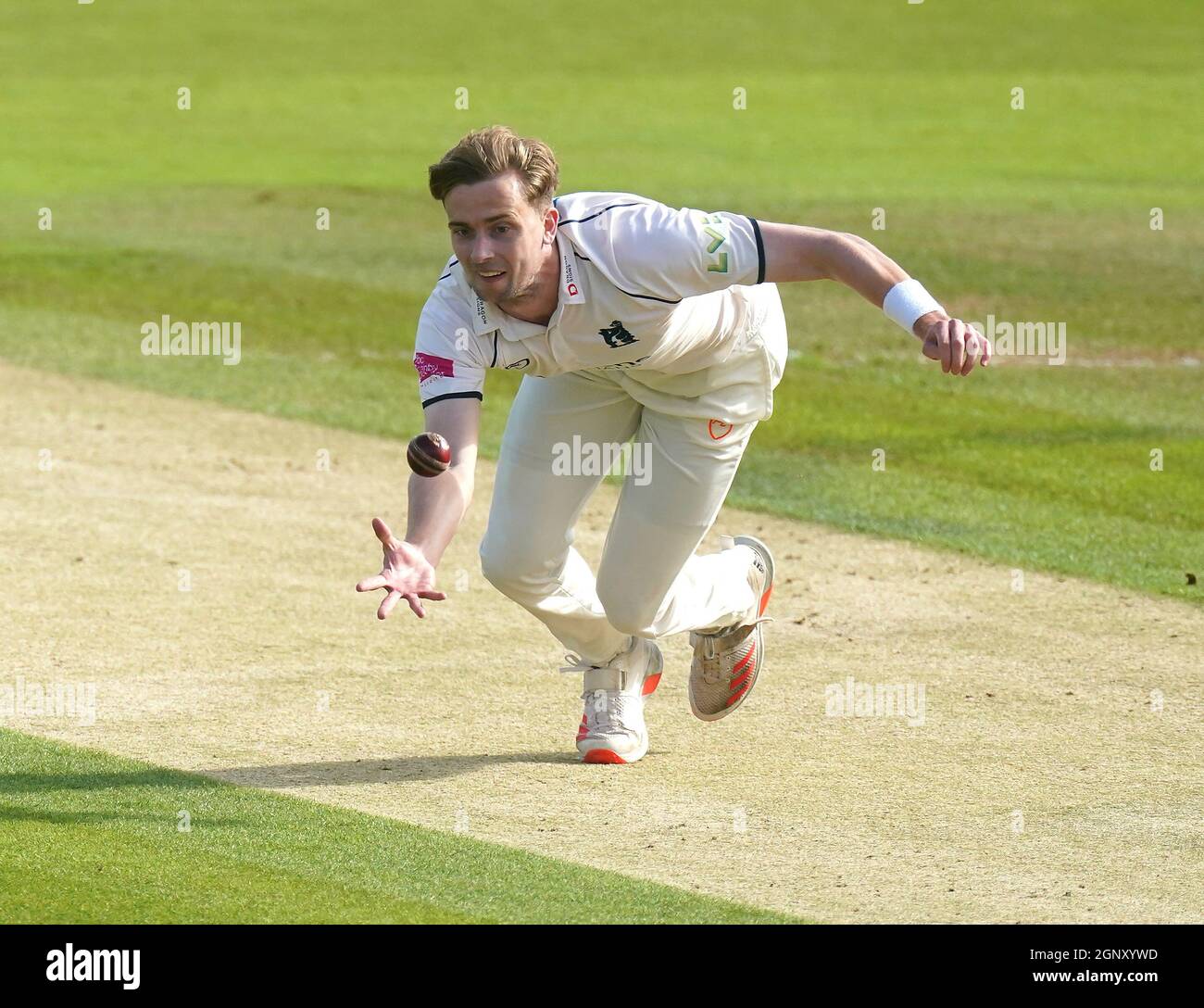 Warwickshire's Craig Miles catches the ball of Lancashire's Alex Davies ...