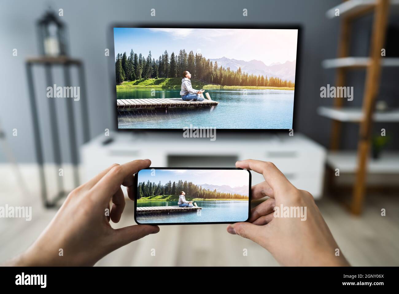 Man Watching TV Streaming From Smartphone Or Mobile Phone Stock Photo ...