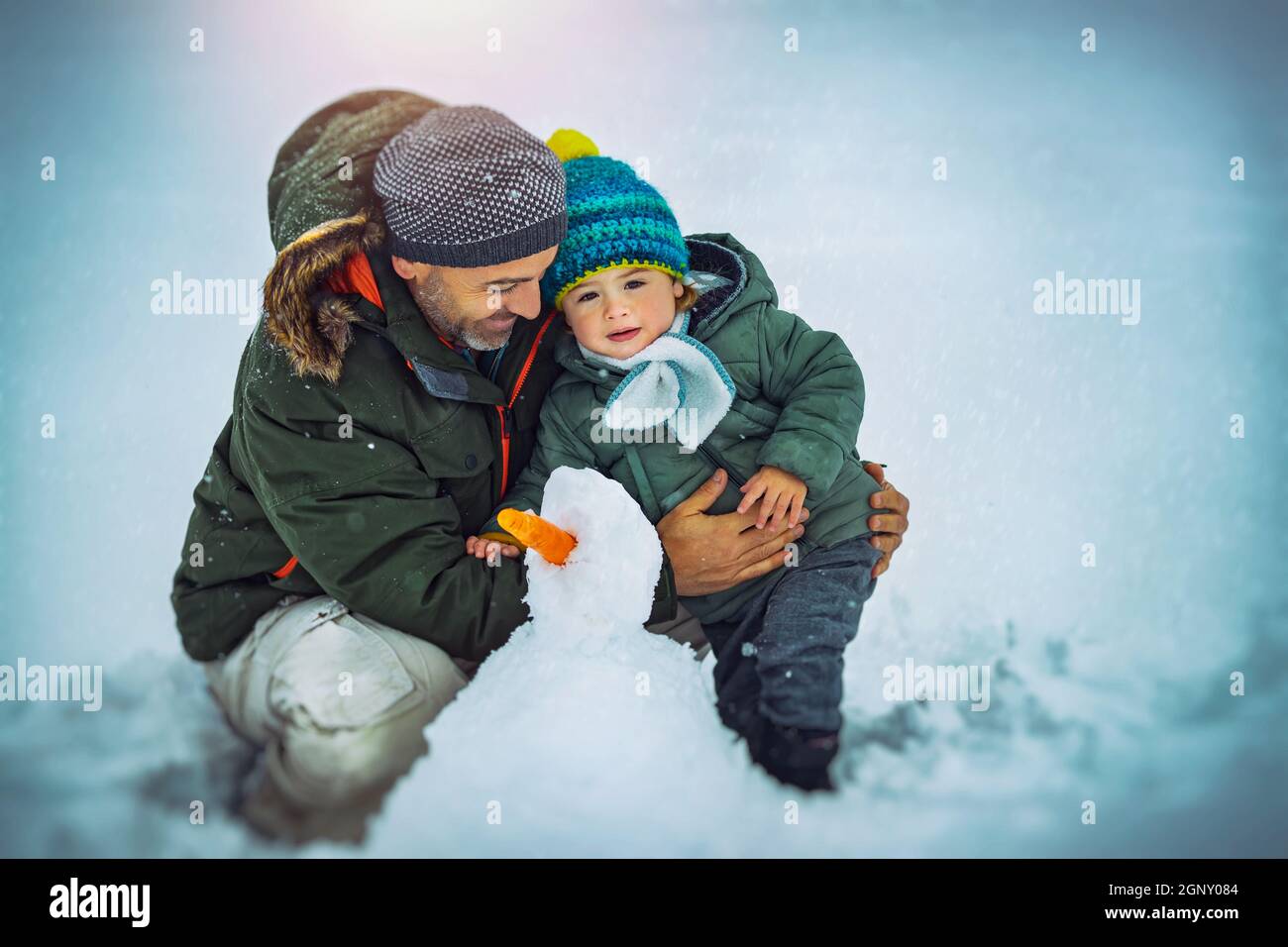 Happy Father with His Little Son Plays with a Snow. Building a Snowman ...