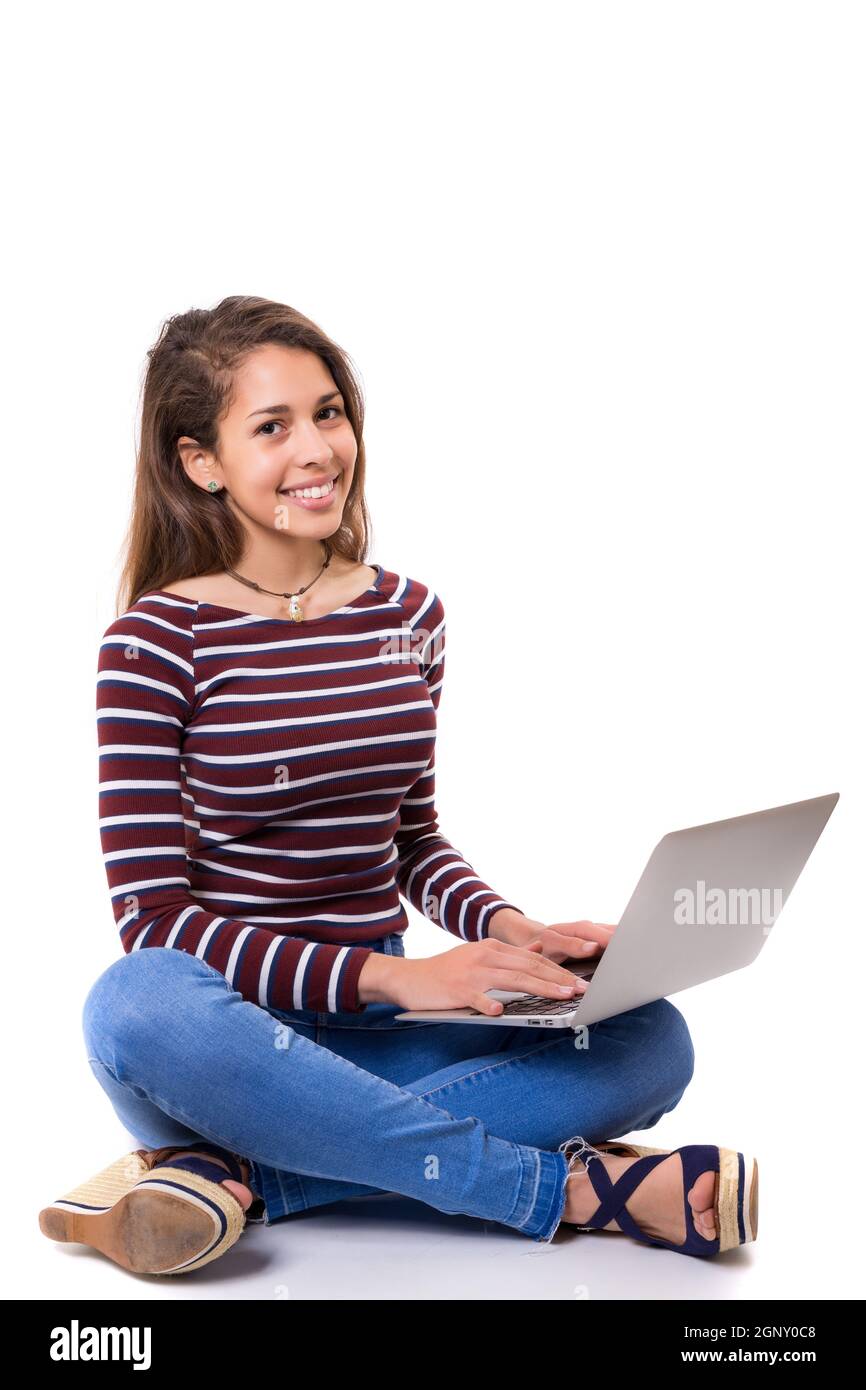 Young student working with her laptop, isolated over a white background ...