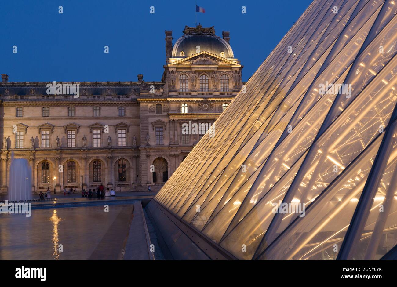 PARIS - AUGUST 15, 2016 Louvre museum at twilight in summer. Louvre ...