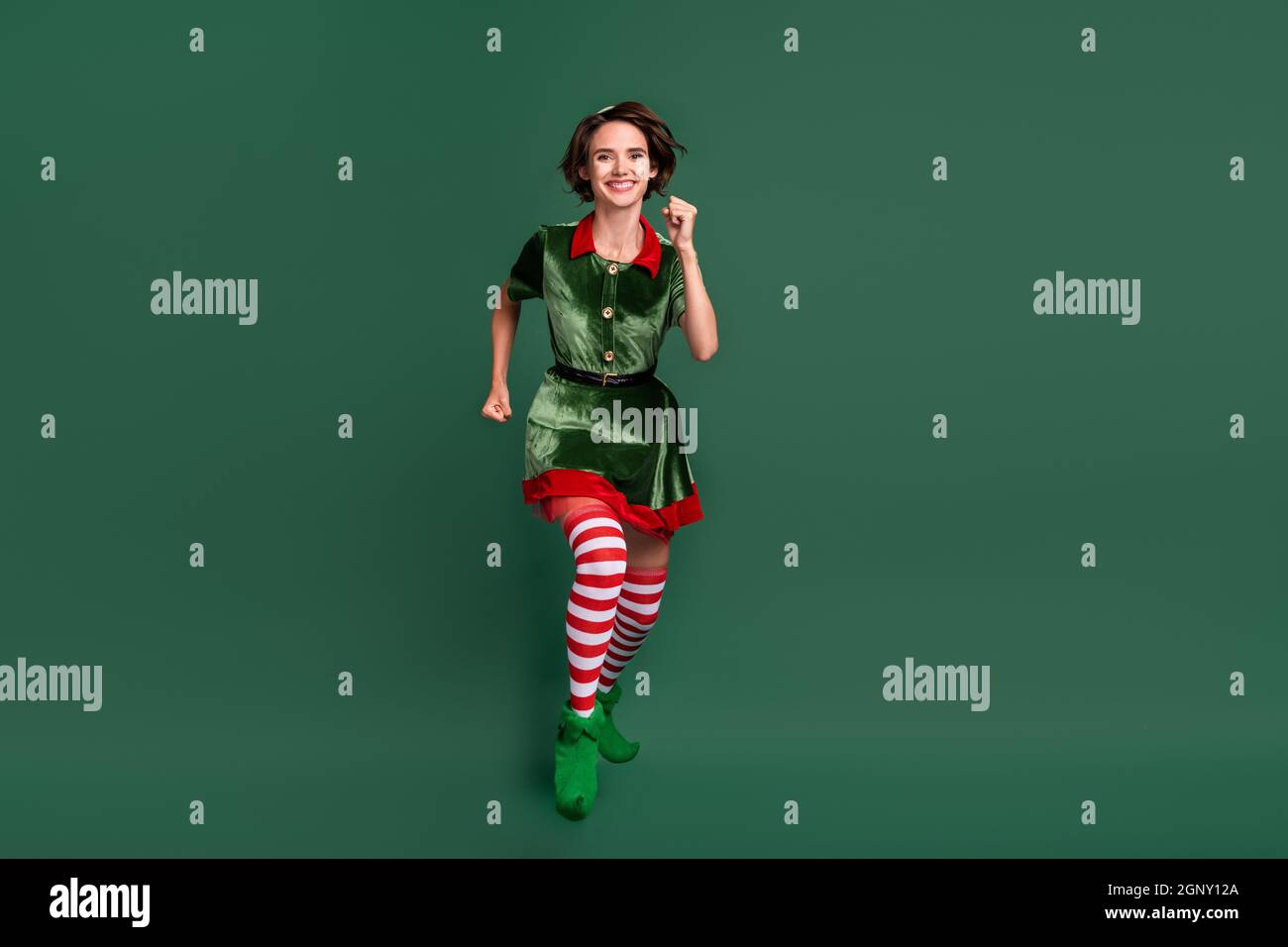 Photo of cute adorable young woman dressed elf costume jumping high ...