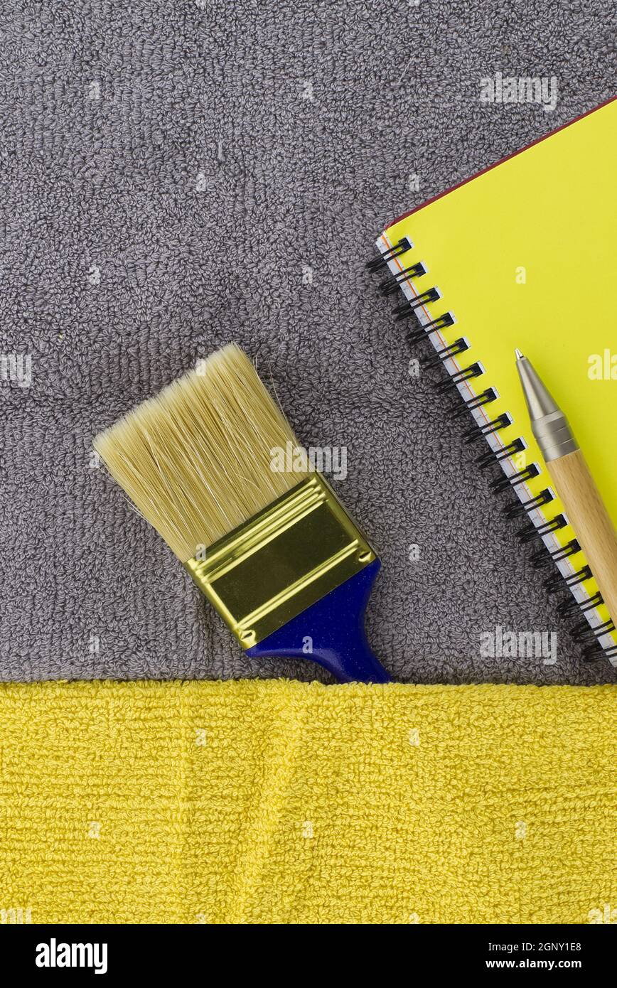 Colorful yellow and grey themed still life with clean paintbrush and ...