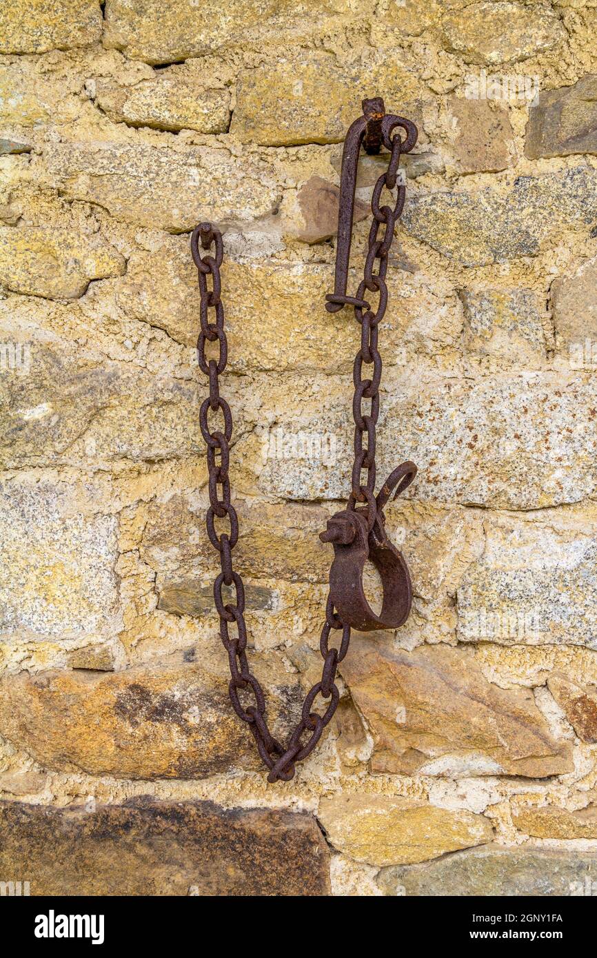 stone wall with fixed rusty rundown chains Stock Photo - Alamy