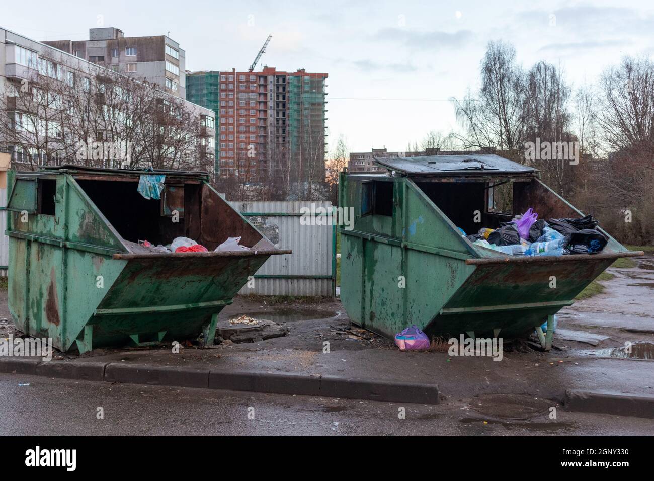 dirty garbage containers, dumpsters with household rubbish in a ...