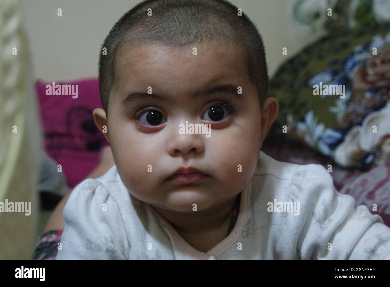 Baby girl with lovely face, big eyes and cute face gesture. Toddler ...