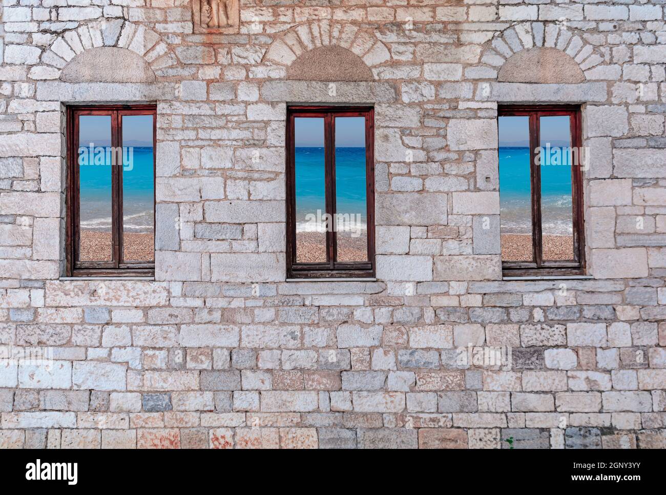 Old stone house with blue sea reflection on windows Stock Photo - Alamy