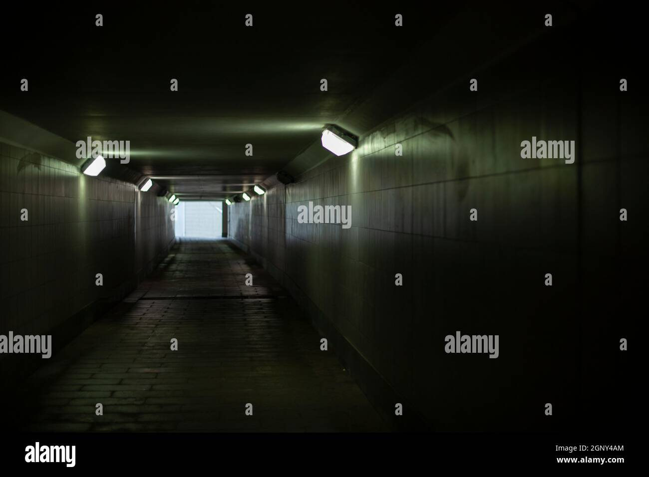 Tunnel under the road. Underground pedestrian crossing. A light in the ...