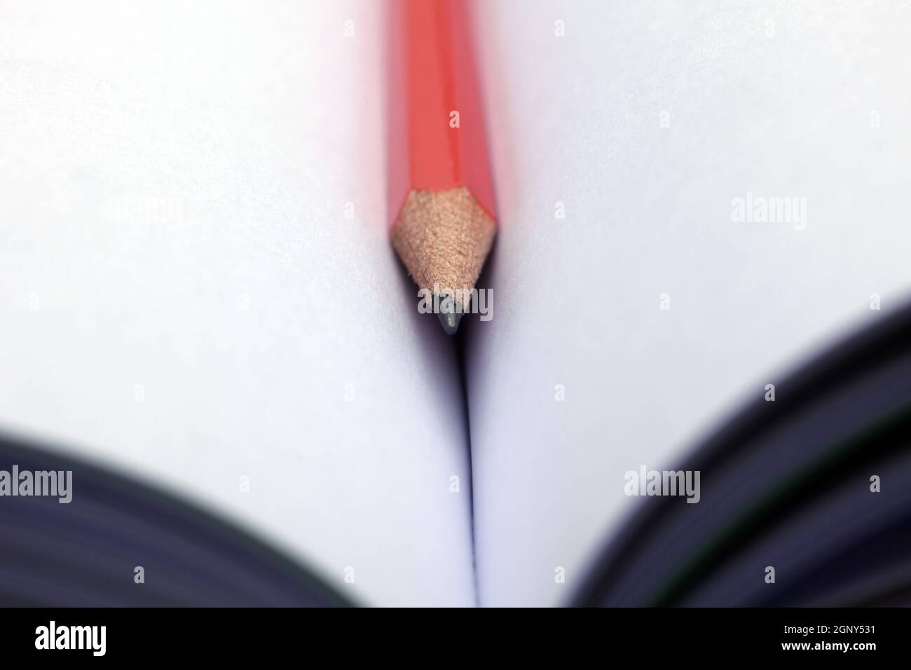 Open book with pencil Stock Photo - Alamy