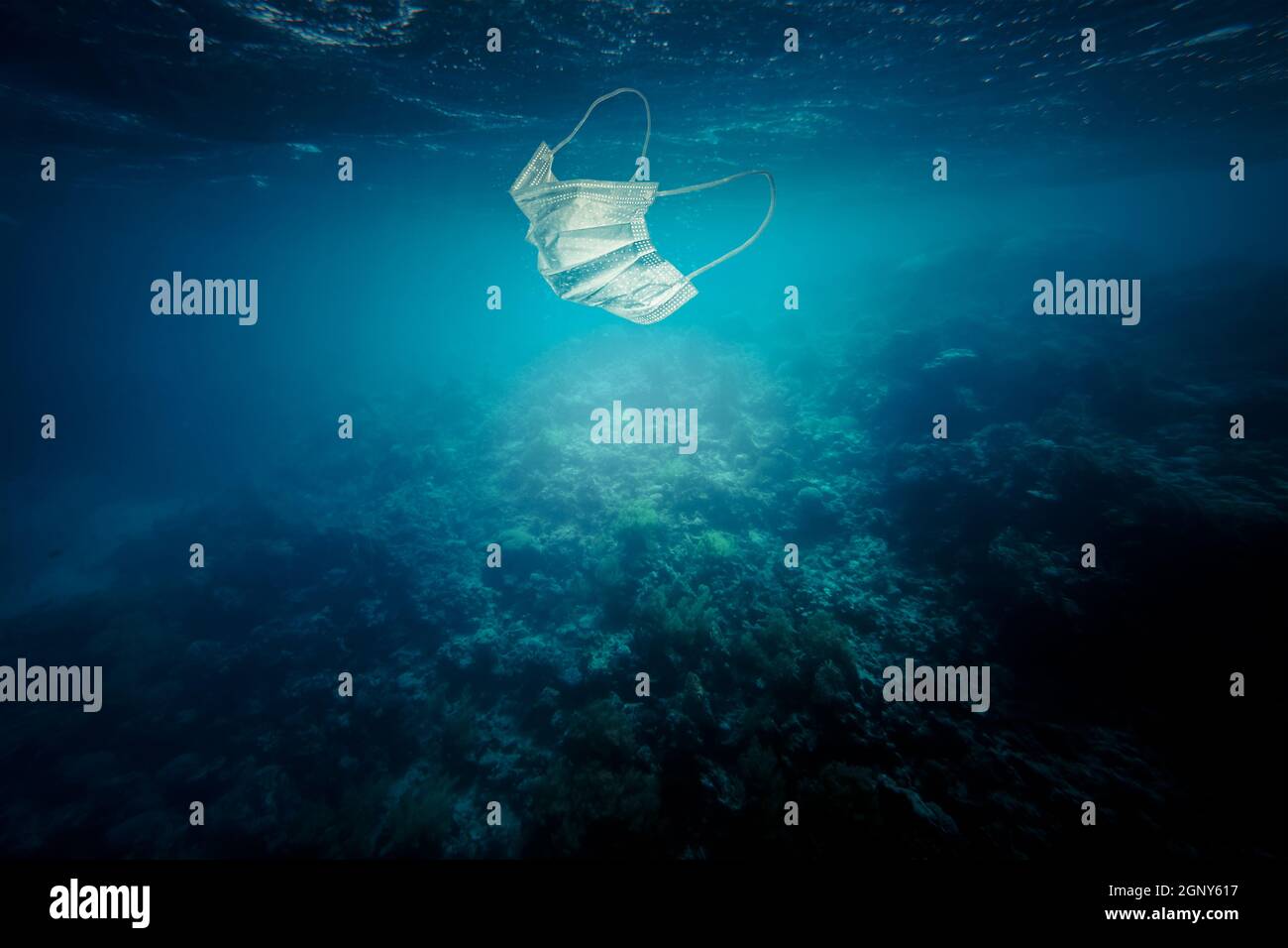 surgical mask floating in the sea. concept of pollution and non ...