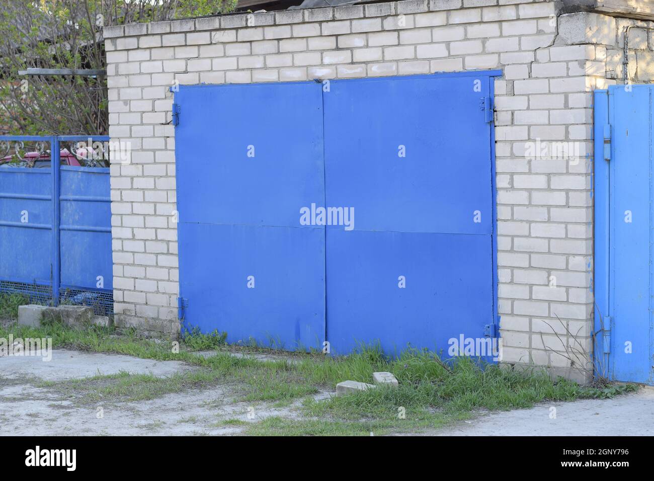 Garage with blue iron gates. A building for storing a car Stock Photo ...