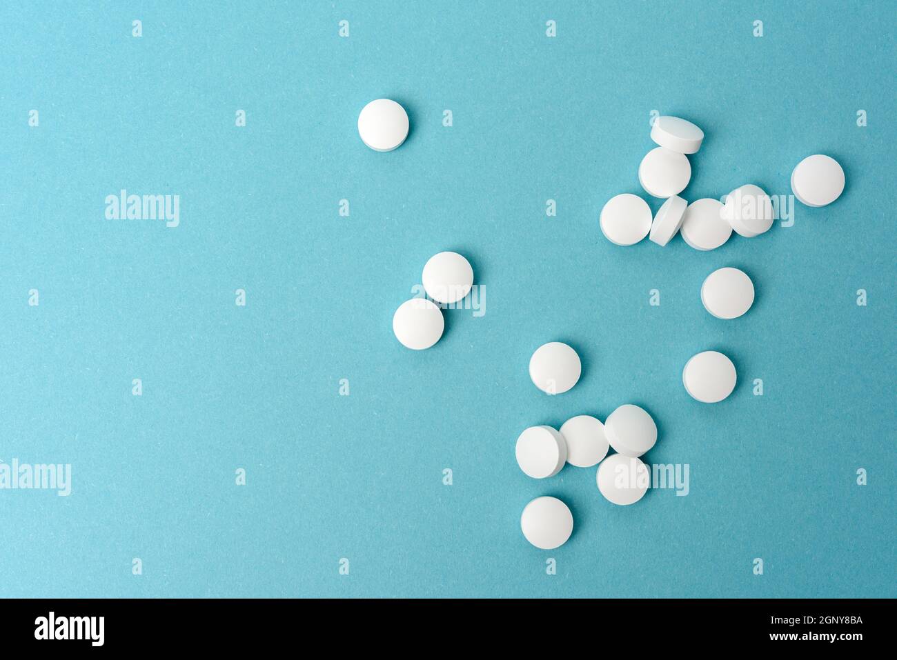 White round pill for healthcare. Medical treatment, bue background, top ...