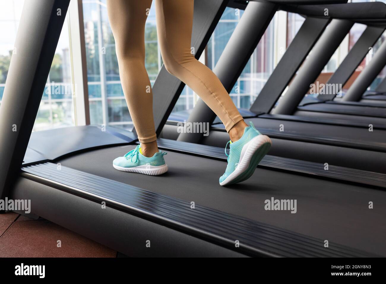 Legs of a sportive woman on a treadmill Stock Photo - Alamy