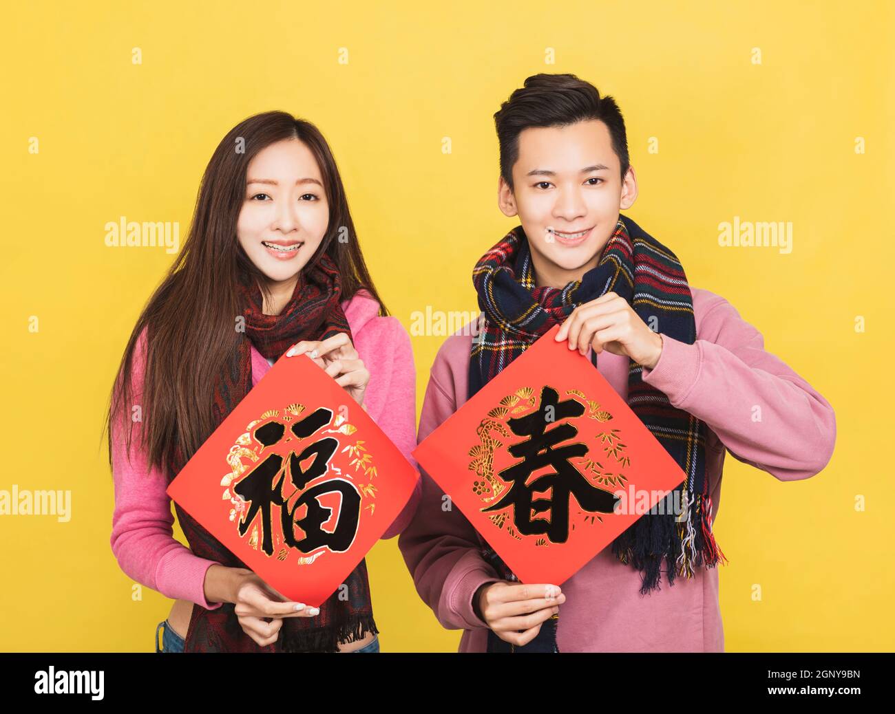happy asian couple showing red couplets and celebrating chinese new ...