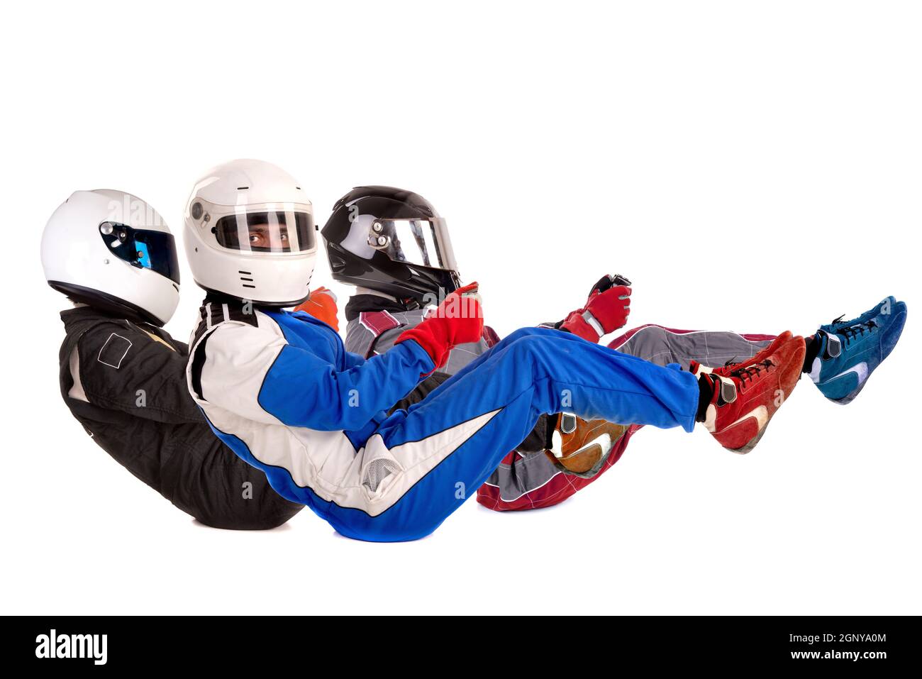Racing driver in racing position with complete gear isolated in white ...