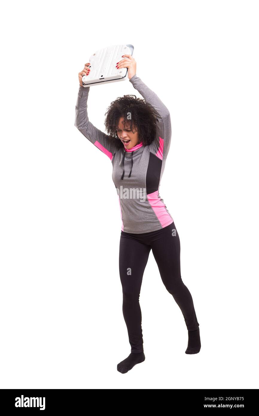 Diet concept - Mad woman destroying her scale Stock Photo - Alamy