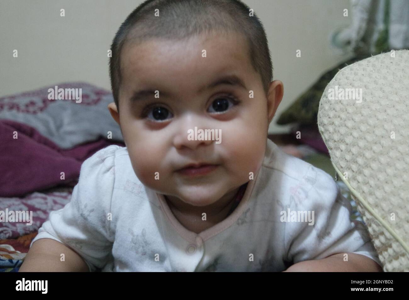 Baby girl with lovely face, big eyes and cute face gesture. Baby with ...