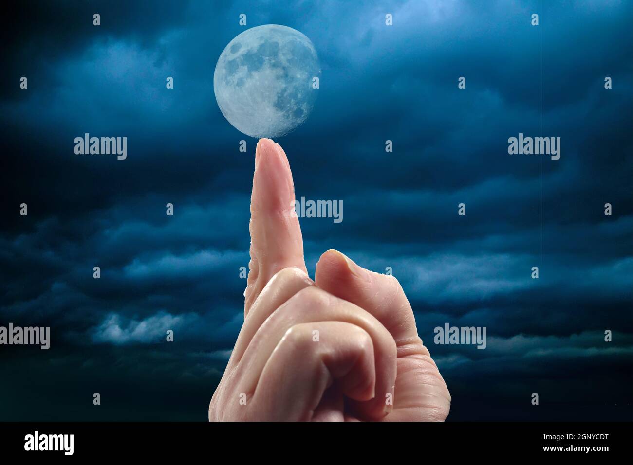 woman's hand with index finger points and sebra to support the moon ...